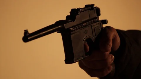 Man's hand aims a C96 Mauser pistol in a... | Stock Video | Pond5