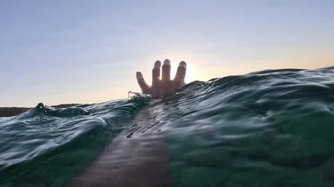 Man's hand drowning in the sea | Stock Video | Pond5