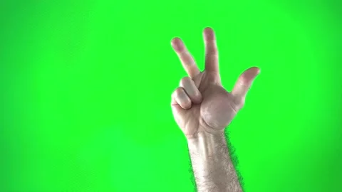 a man's hand on a green background shows... | Stock Video | Pond5