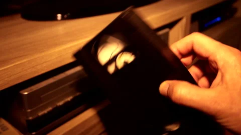 Man's hand holds a VHS cassette in his h... | Stock Video | Pond5