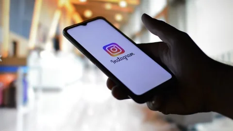 man's hand with instagram icon logo app ... | Stock Video | Pond5