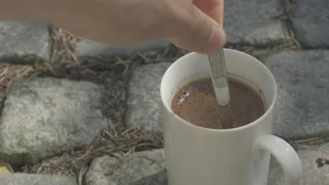 Man’s hand mixing of hot coffee with a... | Stock Video | Pond5