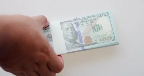 Man's hand pick up bundle of 100 dollar ... | Stock Video | Pond5