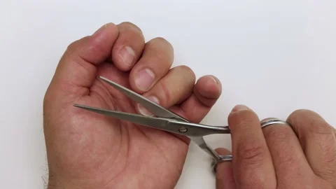 A man's hand scissors the nail on the ri... | Stock Video | Pond5