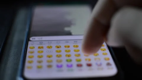 man's hand scrolling cute yellow face em... | Stock Video | Pond5
