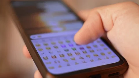 man's hand scrolling emoticon on his pho... | Stock Video | Pond5