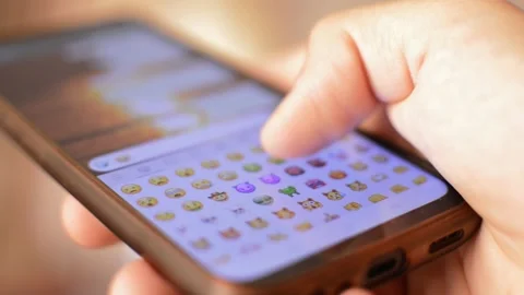 man's hand scrolling emoticon on his pho... | Stock Video | Pond5