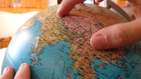 man's hand using a world globe map. spin... | Stock Video | Pond5