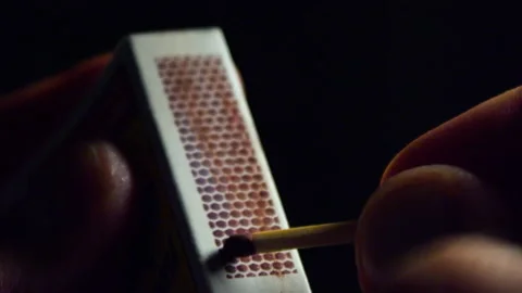 Man's hands lighting up a match, slow mo... | Stock Video | Pond5