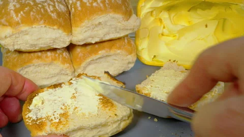Man’s hands spreading butter on a toas... | Stock Video | Pond5