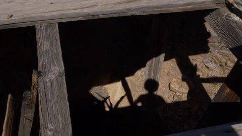 Mans shadow looking down into old vertic... | Stock Video | Pond5