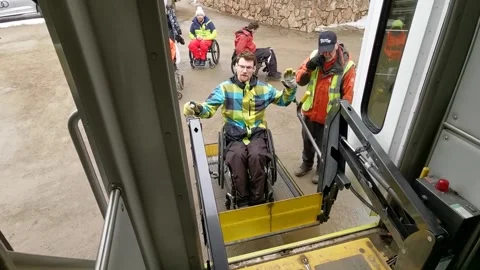 Manual wheelchair user goes up lift and ... | Stock Video | Pond5