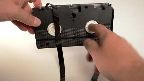 Manually rewinding the VHS tape onto the... | Stock Video | Pond5