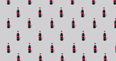 many coca cola bottles on a gray backgro... | Stock Video | Pond5