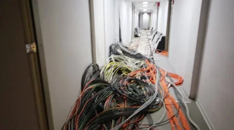 Many wires on floor of corridor and room... | Stock Video | Pond5