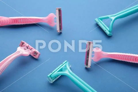 Photograph: Many women razors on the blue background #231474417