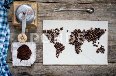 Photograph: Map of the world, lined with coffee beans on old paper ...