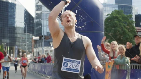 Marathon Runner Pouring Water on His Fac... | Stock Video | Pond5