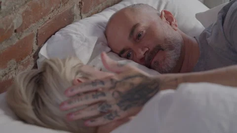 Married Couple Snuggle In Bed | Stock Video | Pond5