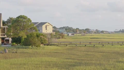 Marsh and houses at magic hour. | Stock Video | Pond5