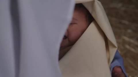 Mary Holding a Crying Baby Jesus | Stock Video | Pond5