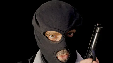 Masked criminal showing gun close up | Stock Video | Pond5