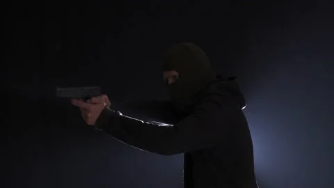 The masked man pointed a gun. Crime and ... | Stock Video | Pond5