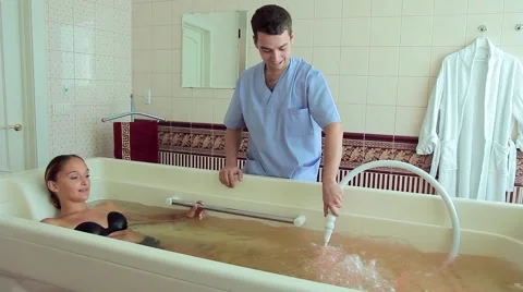 Masseur makes a woman a massage at hydro... | Stock Video | Pond5