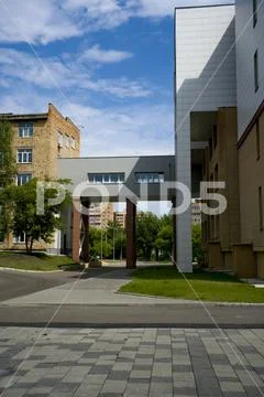 Massive columns supporting the passage between buildings. Stock Photo ...