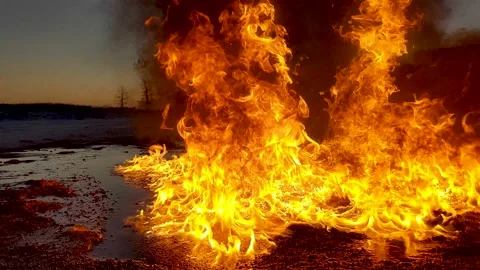 Massive fire burns up oil spill throwing... | Stock Video | Pond5