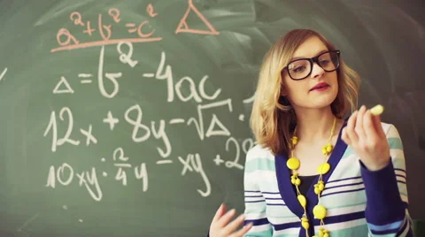 Math teacher standing in the class and e... | Stock Video | Pond5
