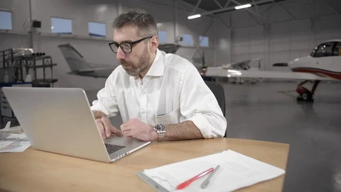 Mature aviation engineer working on comp... | Stock Video | Pond5