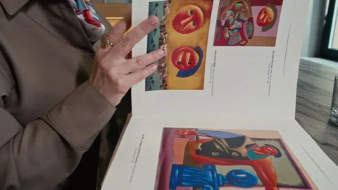 Mature Female Gallerist Turning Pages of... | Stock Video | Pond5