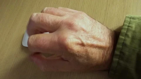 A mature hand stretches out while using ... | Stock Video | Pond5