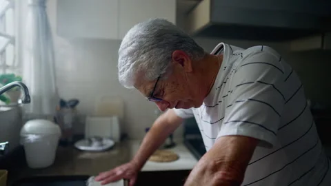 Mature man standing at kitchen counter s... | Stock Video | Pond5