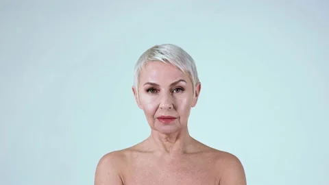 Mature woman with bare shoulders smiling... | Stock Video | Pond5