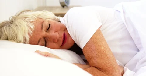 Mature woman being a restless sleeper | Stock Video | Pond5