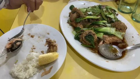 Mature woman eating fish for a lunch in... | Stock Video | Pond5