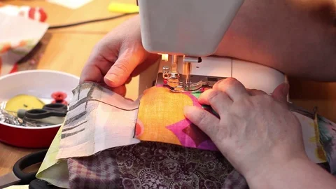 Mature woman is stitching by sewing mach... | Stock Video | Pond5