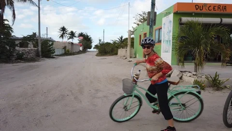 Mature woman straddling her bike, pushes... | Stock Video | Pond5