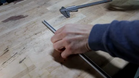 measuring stick measuring a u shaped alu... | Stock Video | Pond5