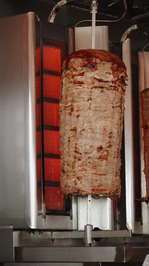 Meat rotates on spit in vertical grill i... | Stock Video | Pond5
