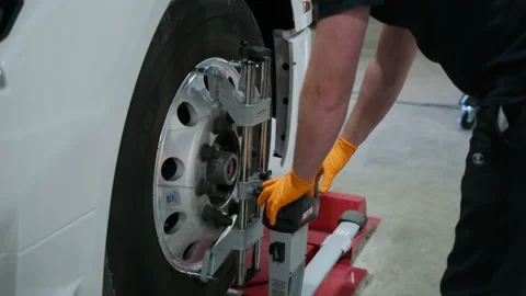 The mechanic alignment the wheels in tru... | Stock Video | Pond5