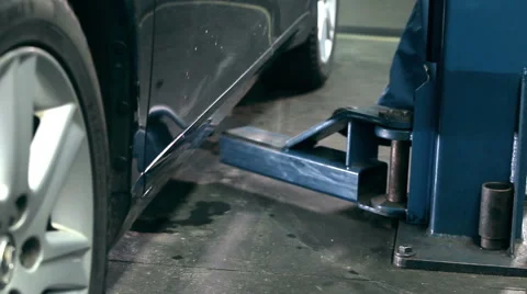 Mechanic going to raise vehicle on the c... | Stock Video | Pond5