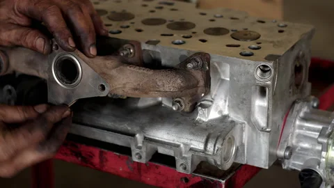 Mechanic Installs Exhaust Manifold on Re... | Stock Video | Pond5