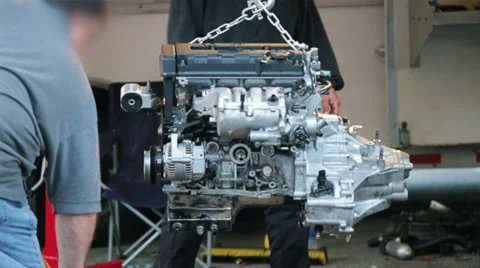 Mechanic lifting car's engine | Stock Video | Pond5