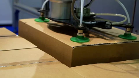 Mechanical manipulator stacks cardboard ... | Stock Video | Pond5
