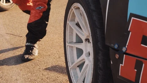 Mechanics change the wheel on a racing c... | Stock Video | Pond5