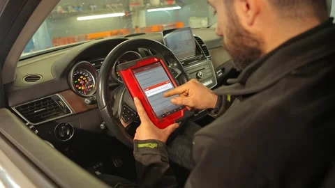 A mechanic's hands use a diagnostic tool... | Stock Video | Pond5