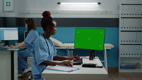 Medical assistant using computer with ho... | Stock Video | Pond5